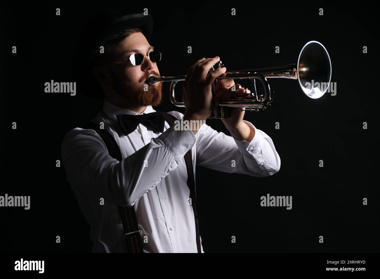 Professional musician playing trumpet on black background Stock Photo ...