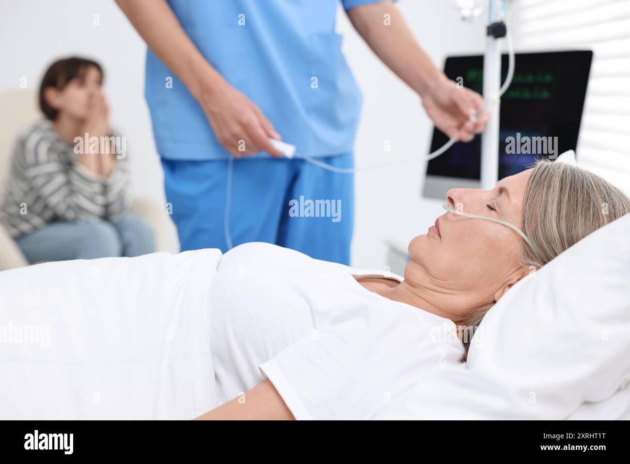 Coma patient. Doctor near unconscious mature woman in hospital Stock ...