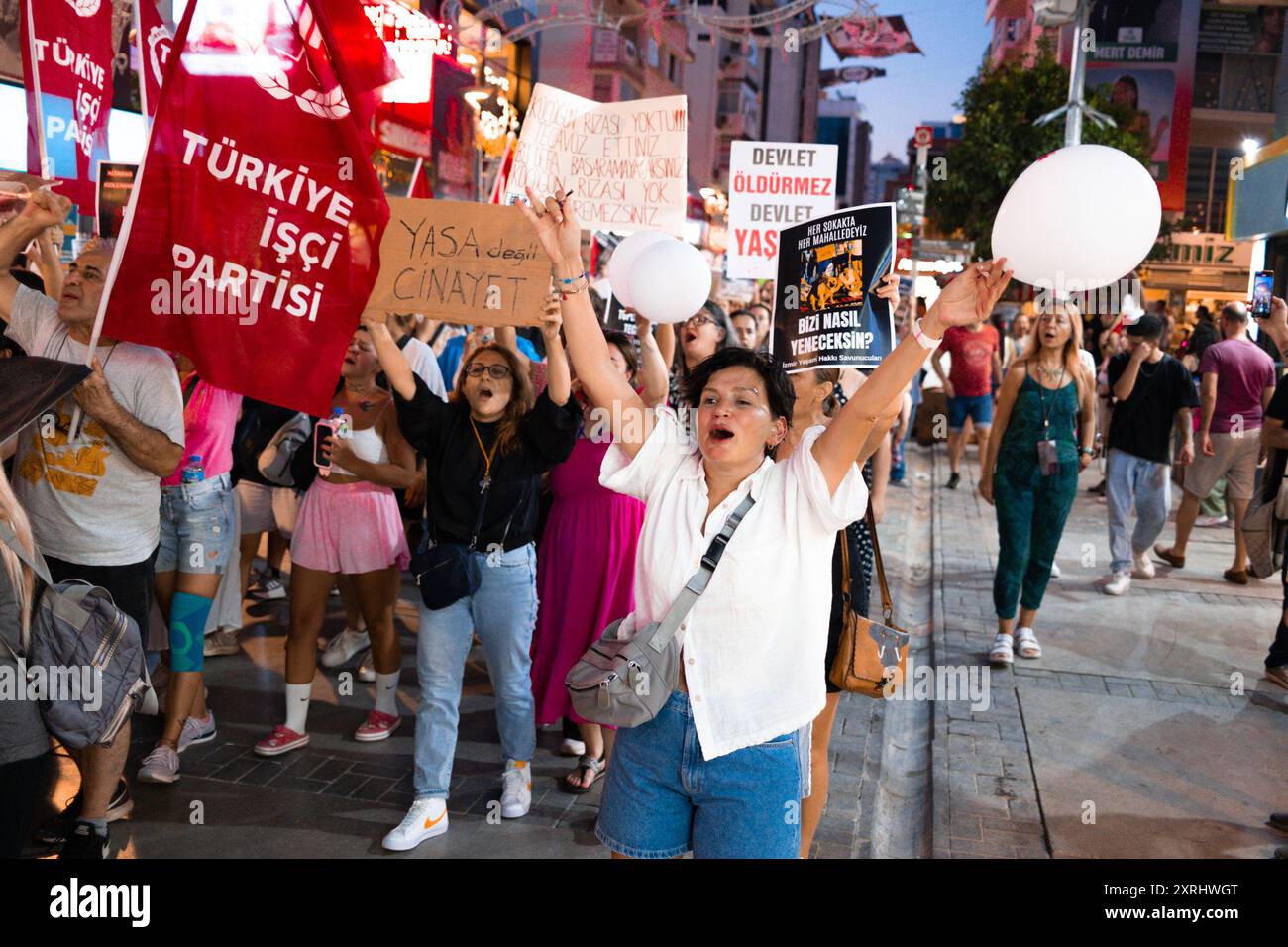 Protesters shouting slogans hold placards and balloons during the rally ...