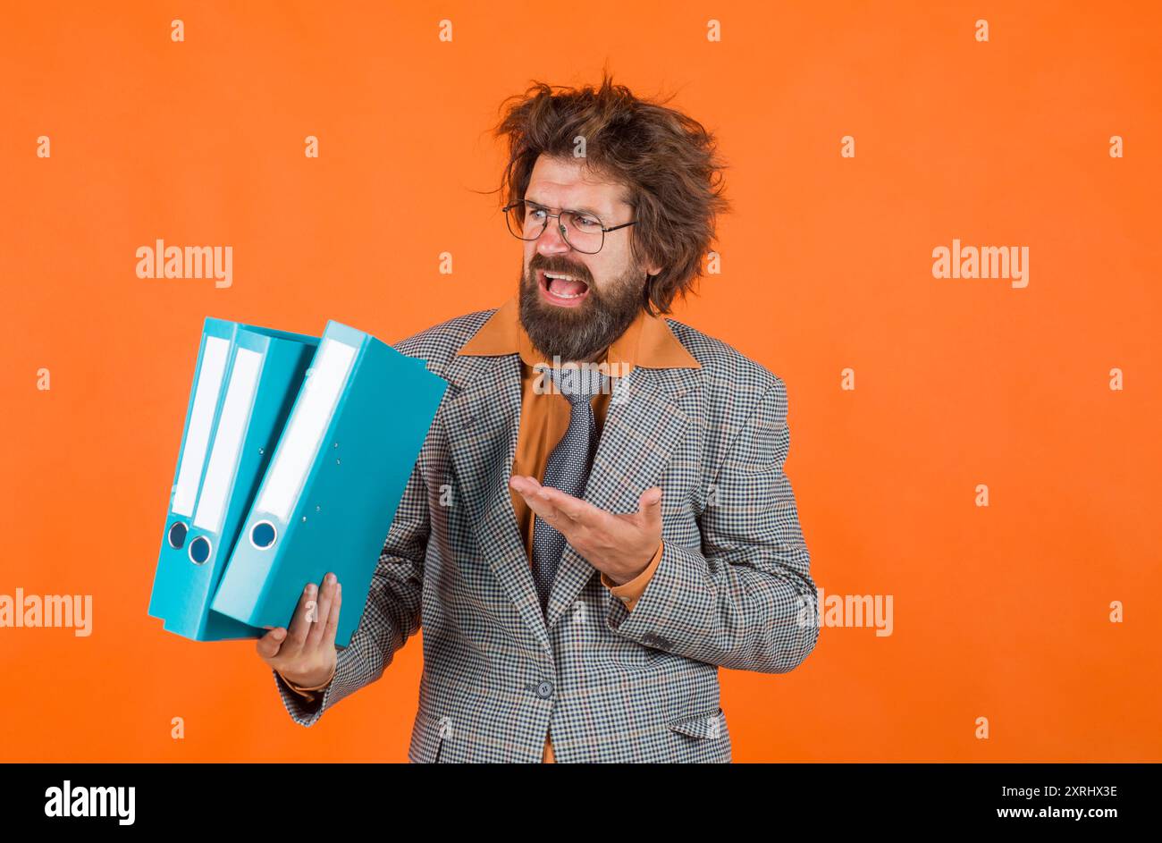 Confused business man in formal wear with folders. Portrait of bearded ...
