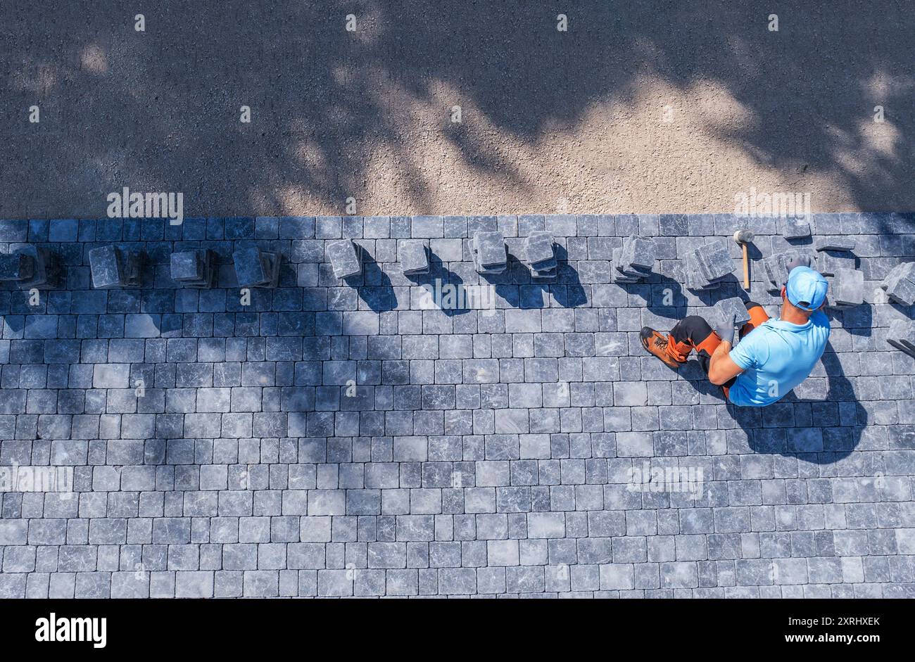 Construction worker carefully positions hi-res stock photography and ...