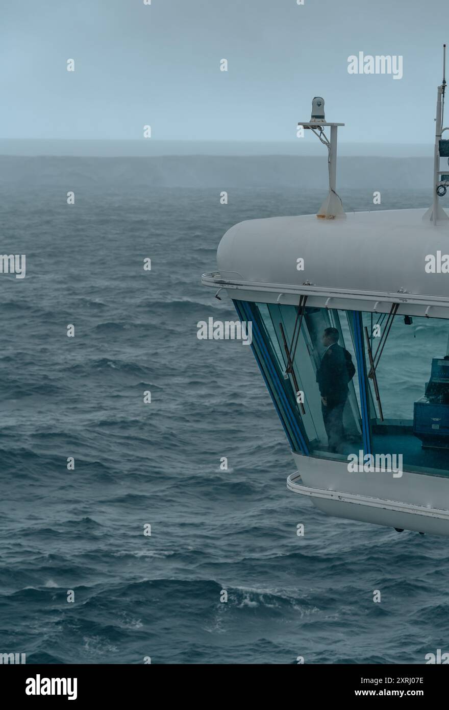 Antarctica - December 26th 2023 - Photo of A23a Iceberg from Cruise Ship. Member of crew watches ...