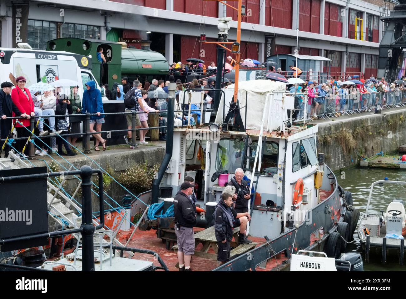 Steam train, harbour master and visitors in front of the M Shed ...