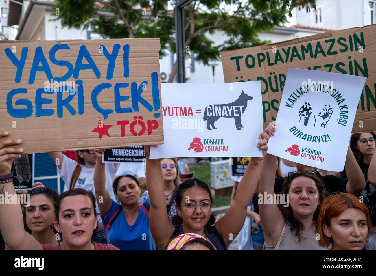 Protesters hold a banner and placards during the rally. Last week, the ...