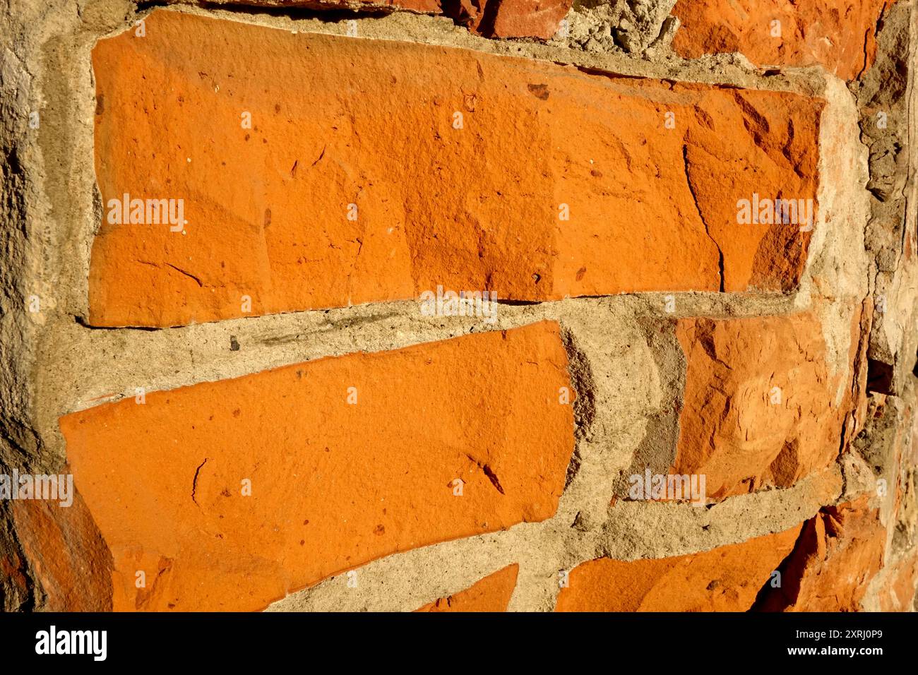 Detailed texture of a rustic orange brick wall with visible mortar ...
