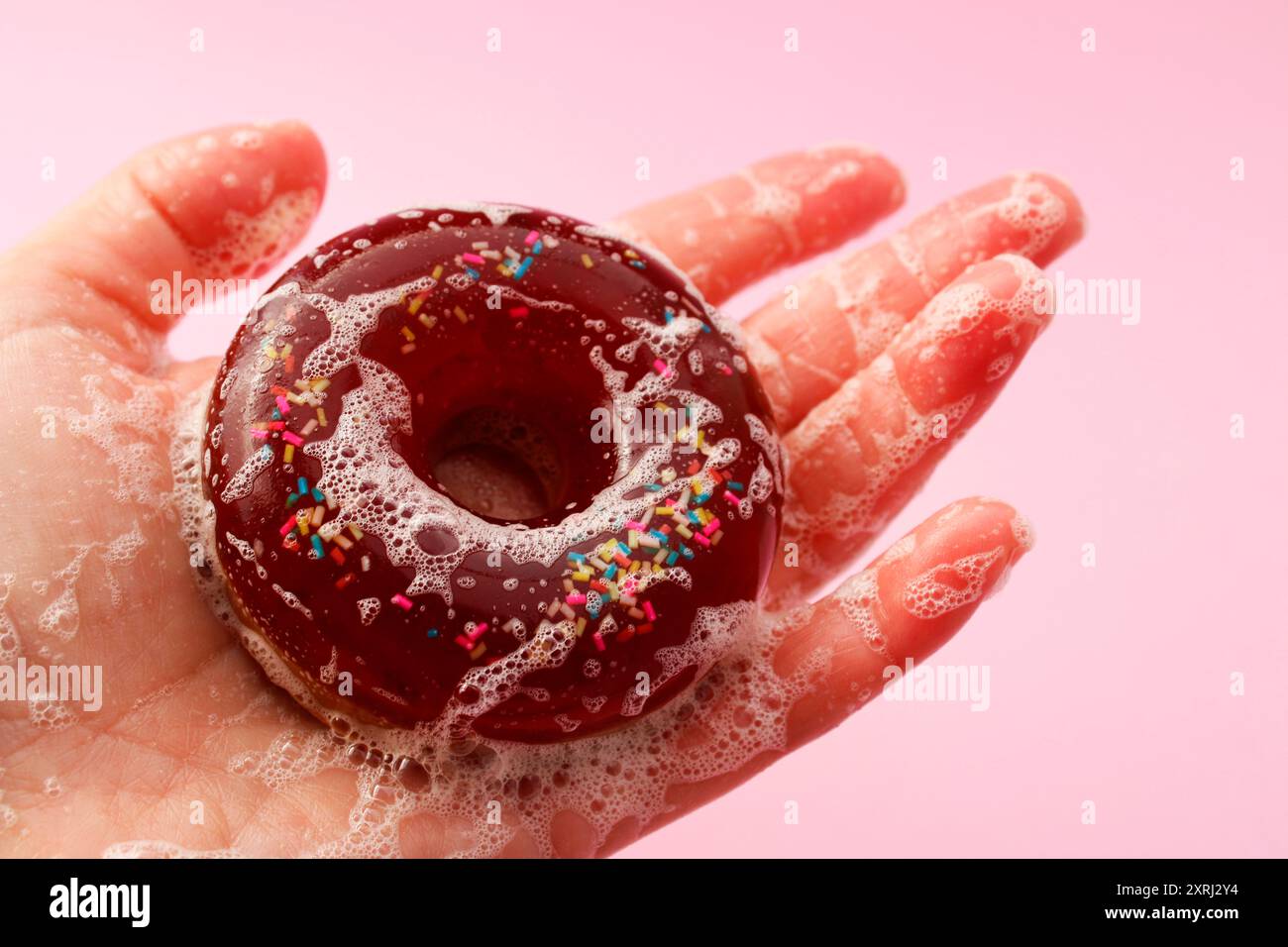 Hand holding donut shaped soap Stock Photo - Alamy