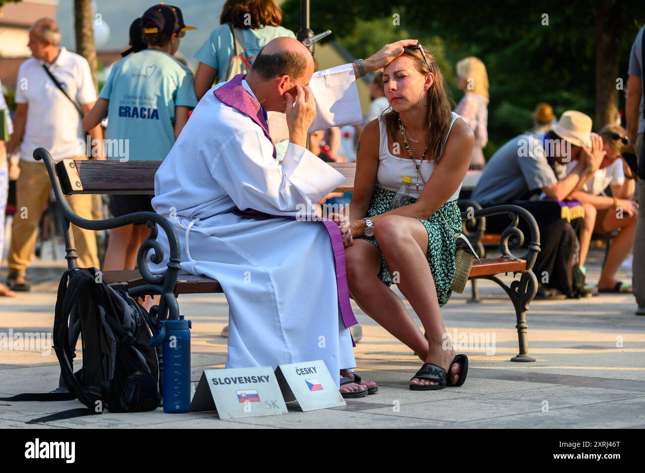 A Catholic priest blessing and giving absolution to a penitent after ...