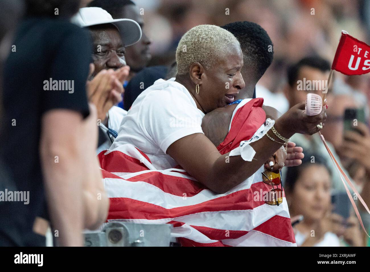 Shelby McEwen, of the United States, right, is embraced by his mother ...
