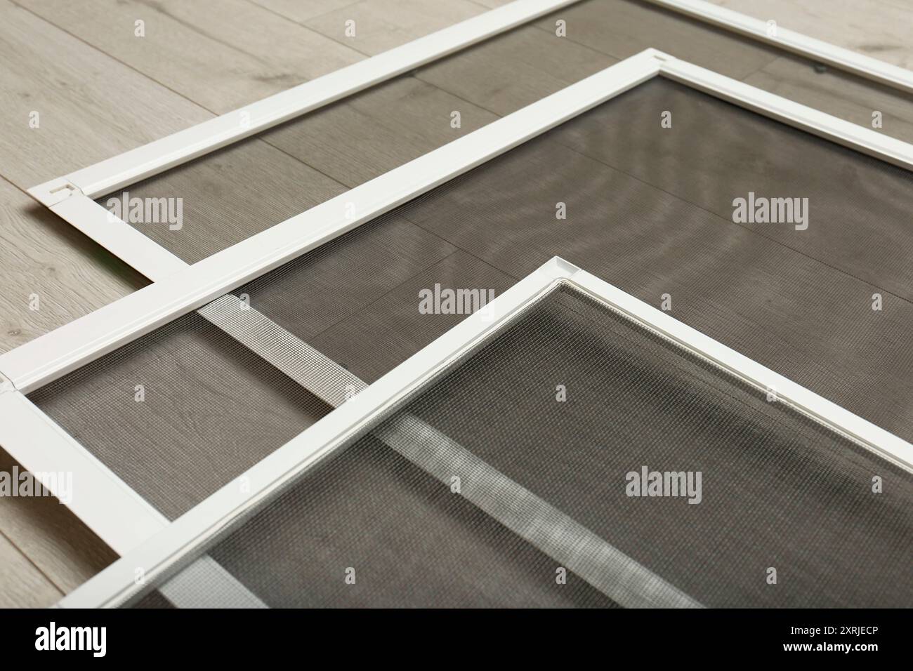 Set of window screens on wooden floor, closeup Stock Photo - Alamy