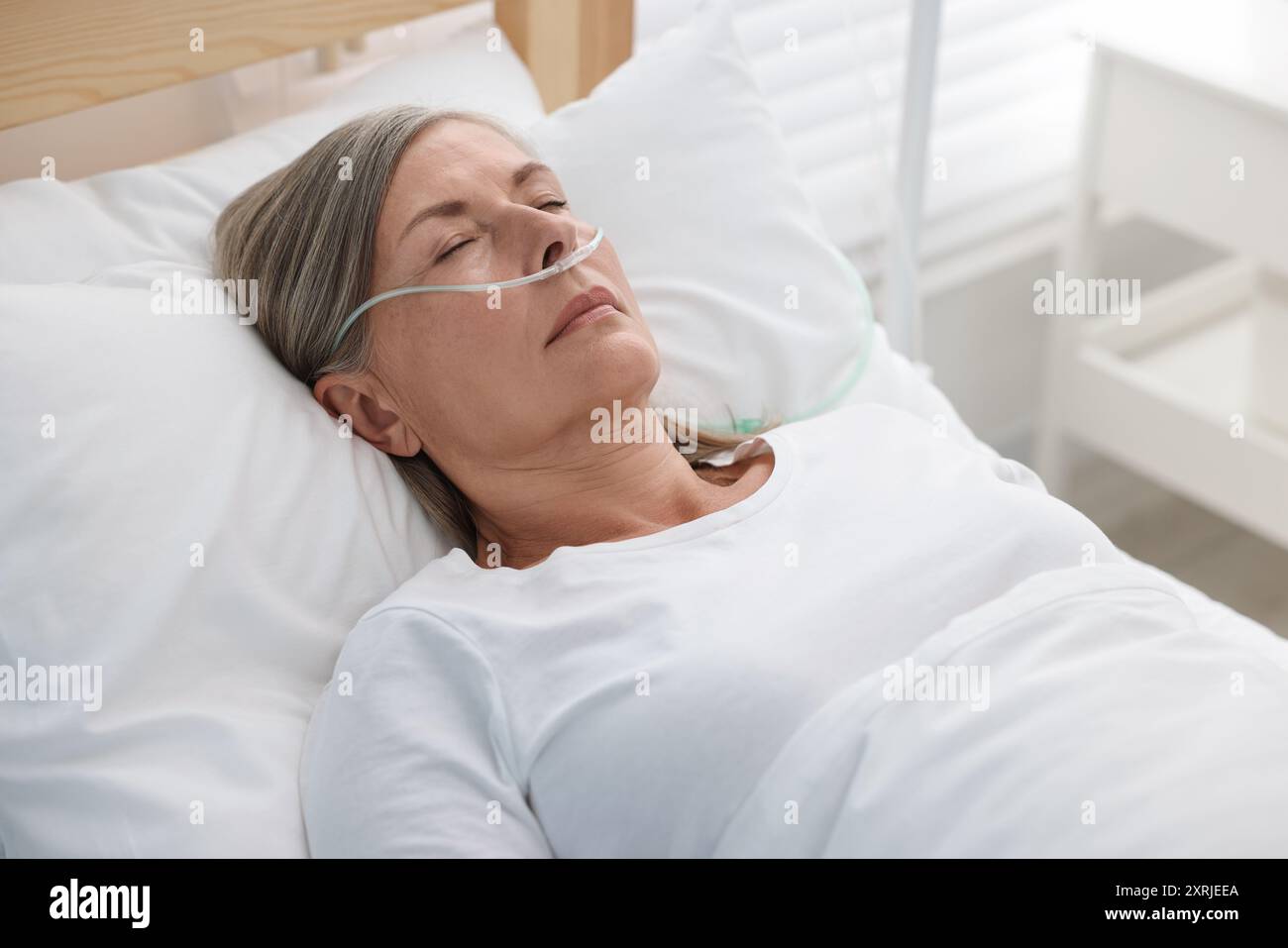 Coma patient. Mature woman sleeping in hospital bed Stock Photo - Alamy