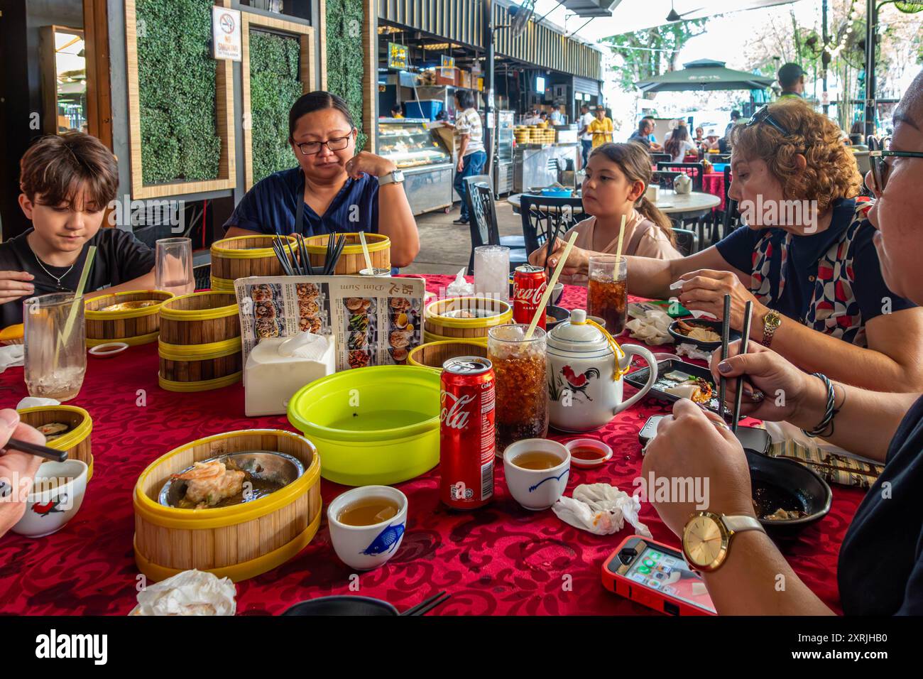 A family sit and eat a meal together at The Fu Er Dai restaurant in ...