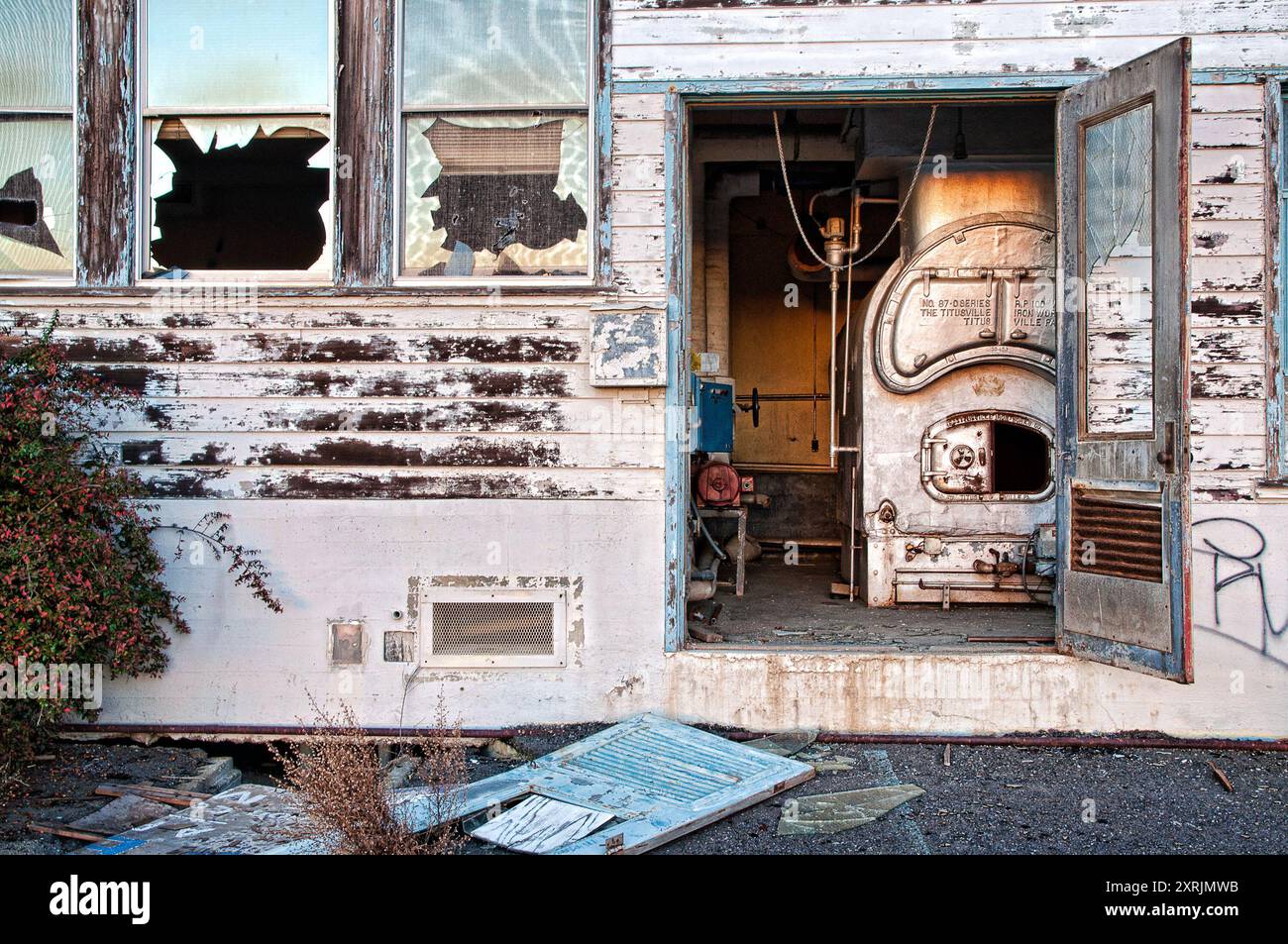 In an abandoned shipyard, an old building is falling apart. Broken ...