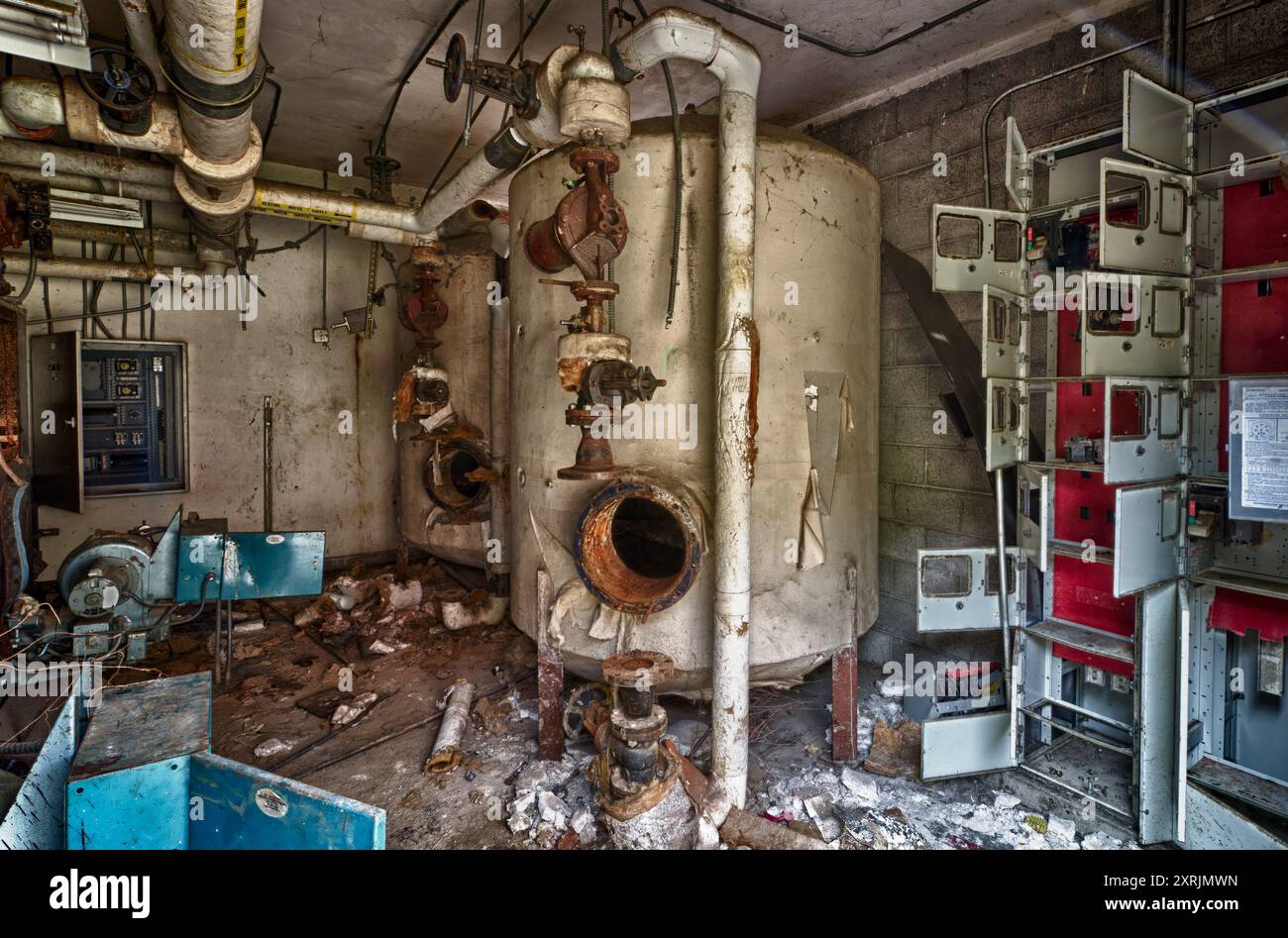 An old utility room with walls that are crumbling, broken doors and ...
