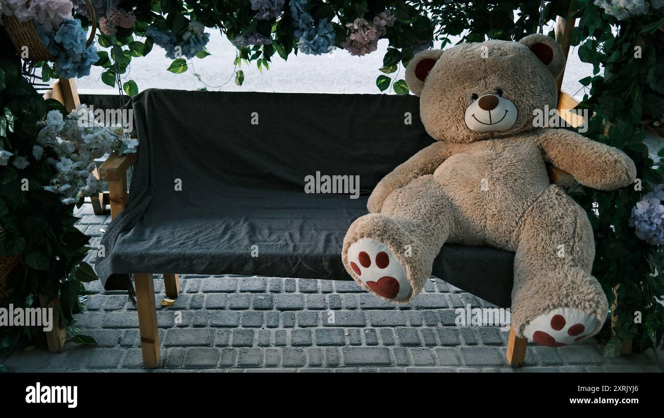 teddy bear on a bench under a flower arch Stock Photo - Alamy