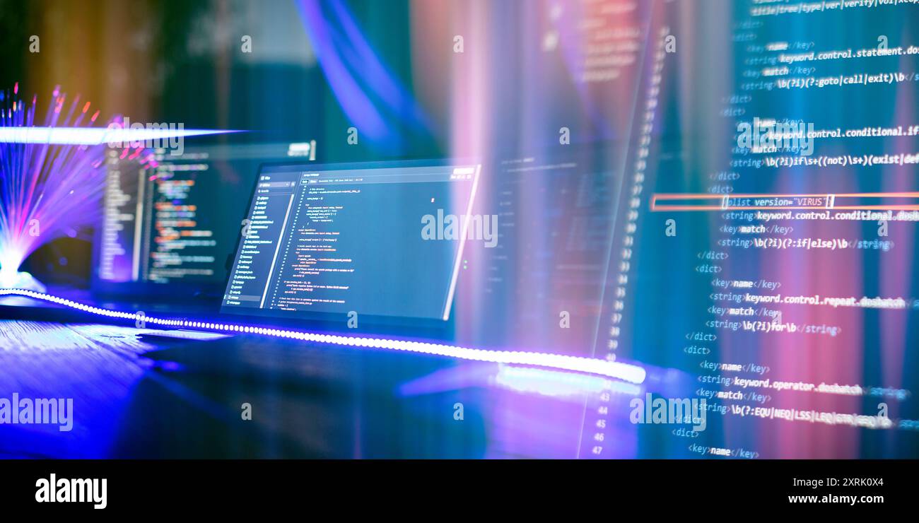 Program code on a computer monitor with fiber optic background ...