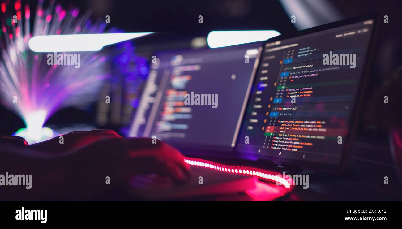 Program code on a computer monitor with fiber optic background ...