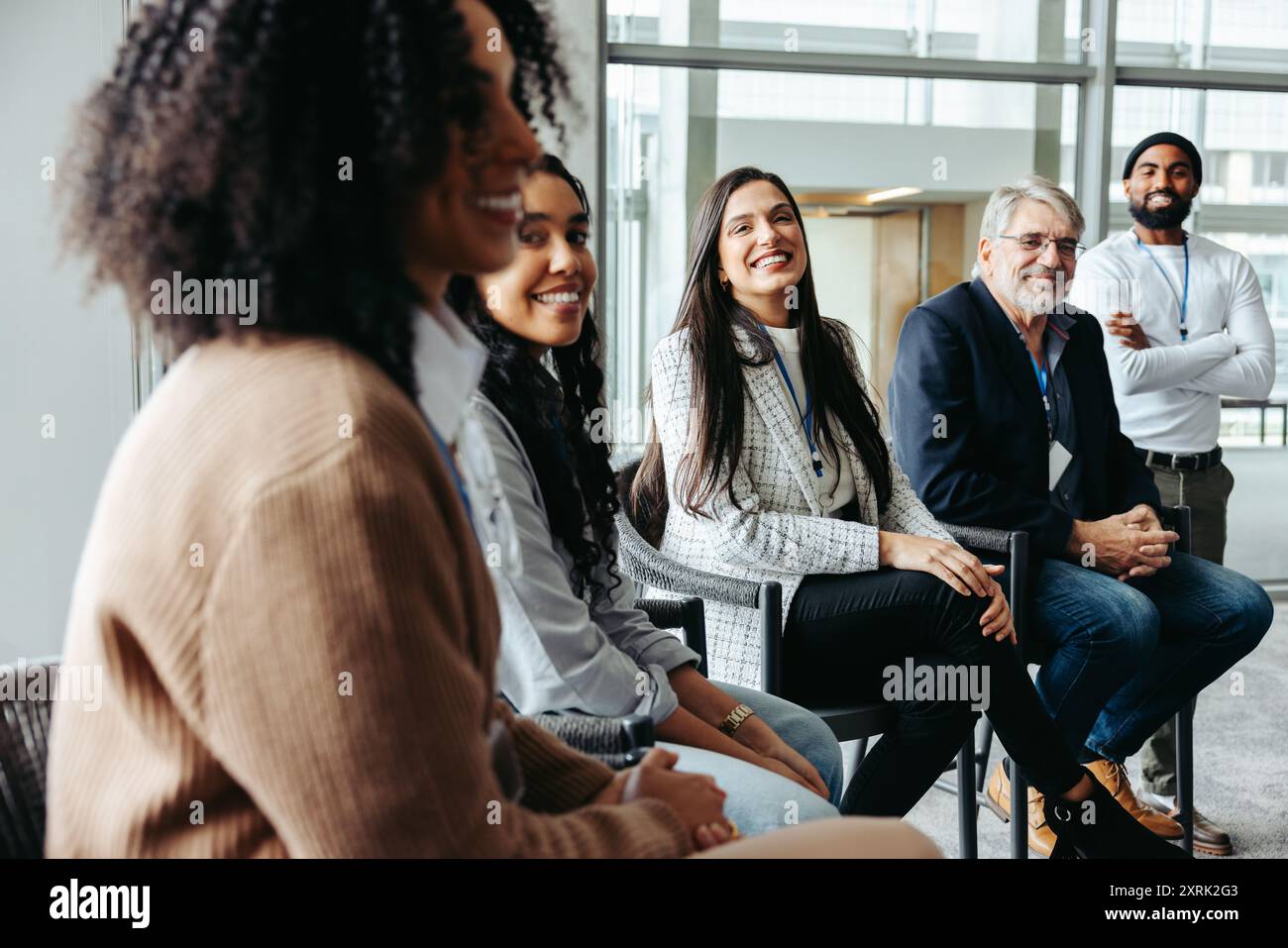 Multiethnic group of colleagues networking, laughing, and enjoying a casual business meeting ...