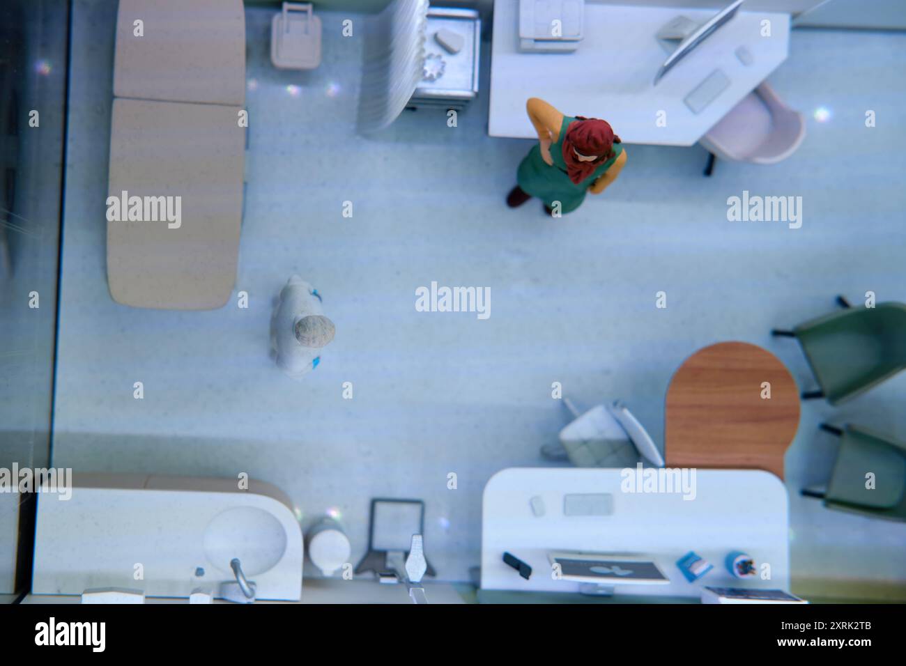 Top view of a miniature medical office with two figures. Aerial ...