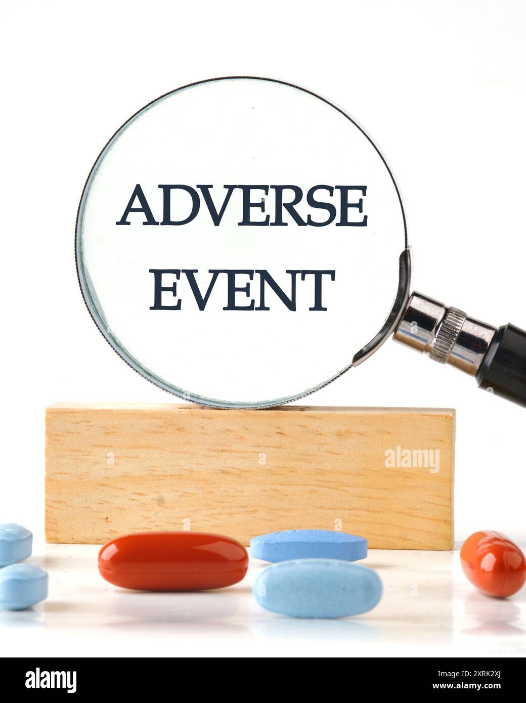 Medical concept. Text ADVERSE EVENT through a magnifying glass on a ...