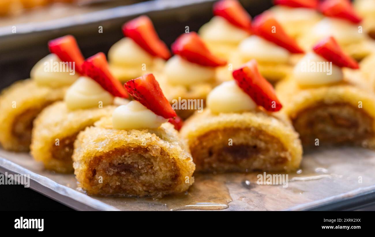 Sponge puff pastry rolls with honey decorated with a slice of ...