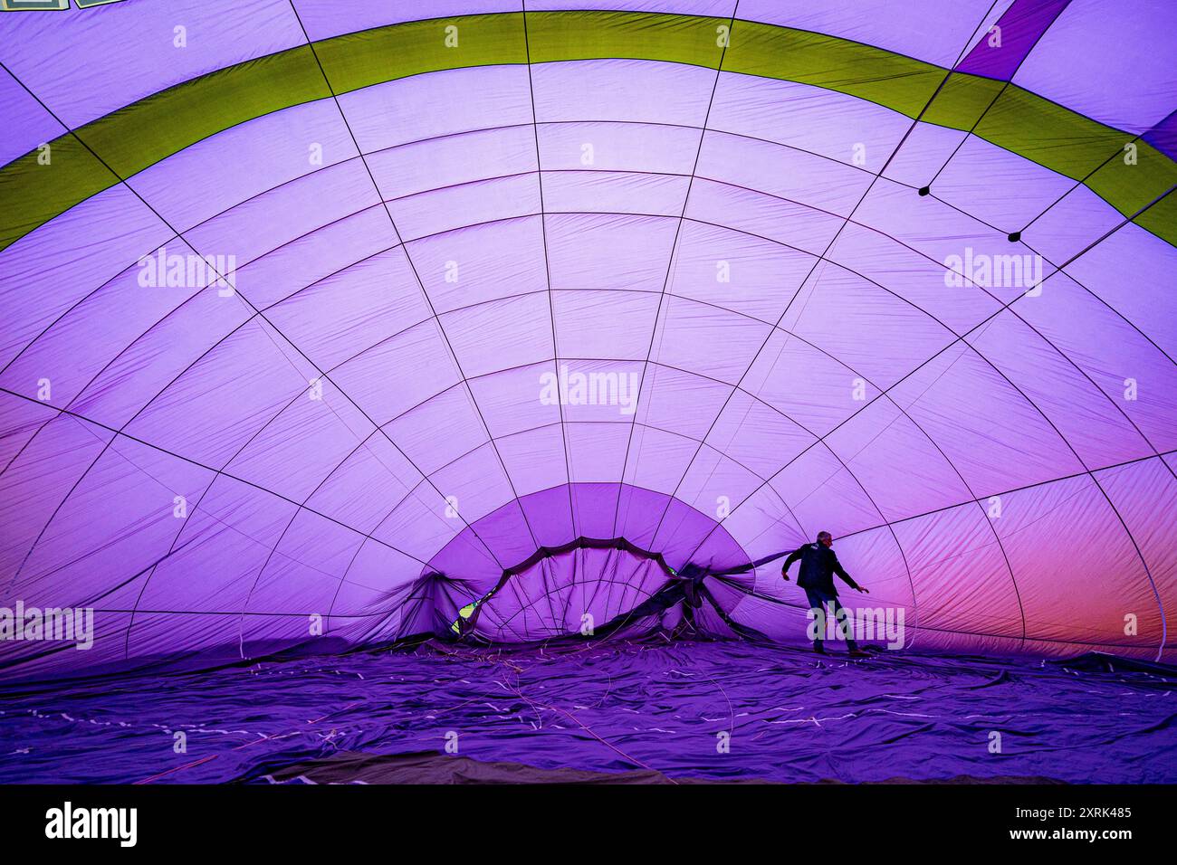 A hot air balloon pilot checks the rigging inside a balloon canopy at the 46th Bristol ...