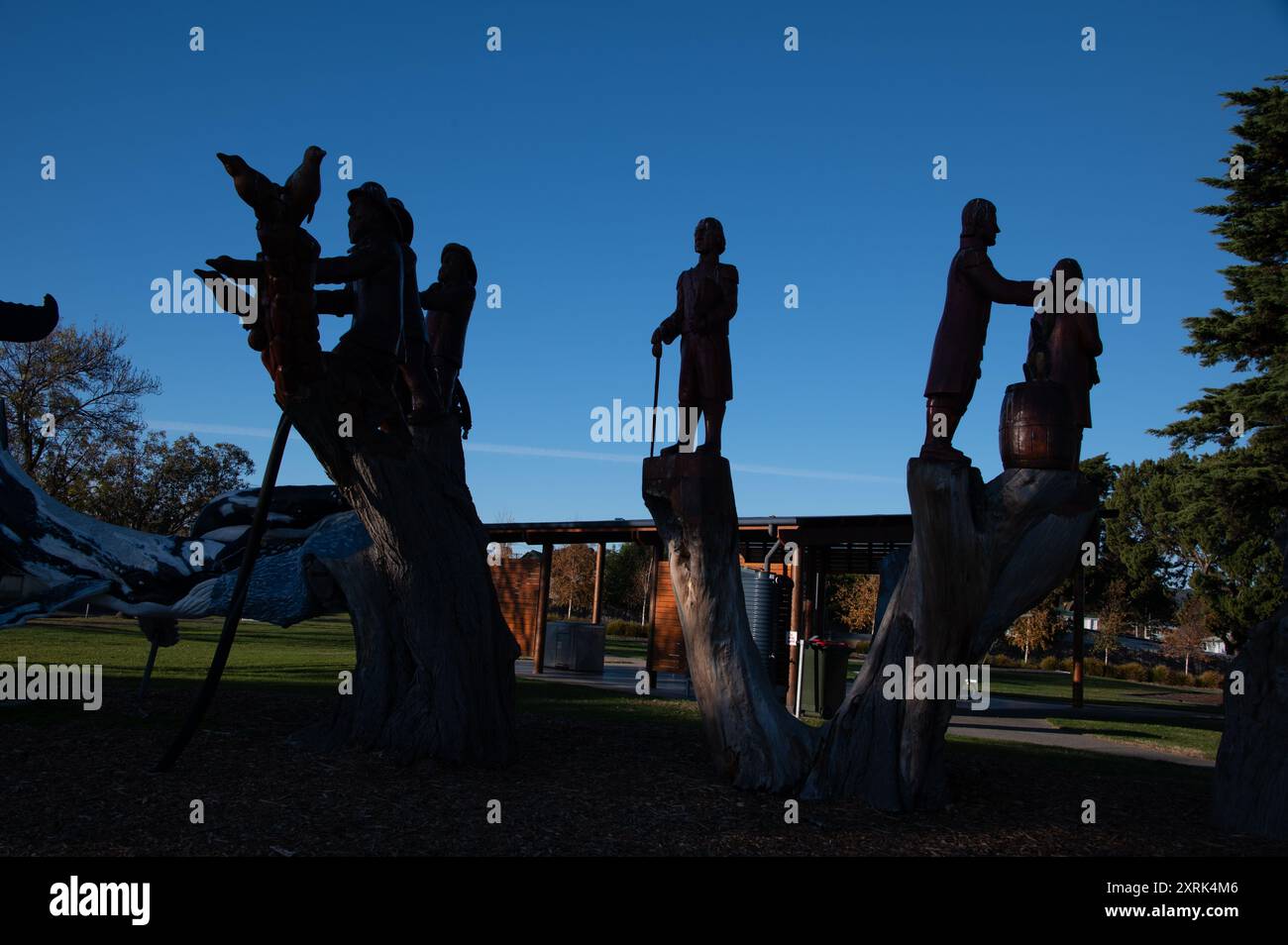 Carved wooden figures/ sculptures overlooking the wide estuary of the ...