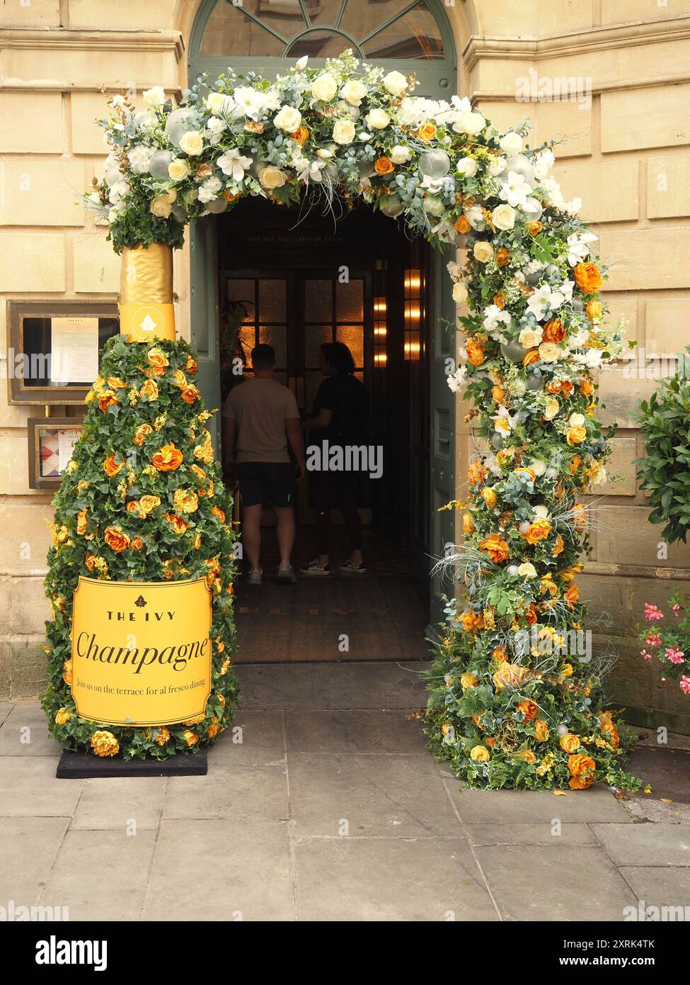 Flower arch and giant decorated Champagne bottle at the doorway to The ...