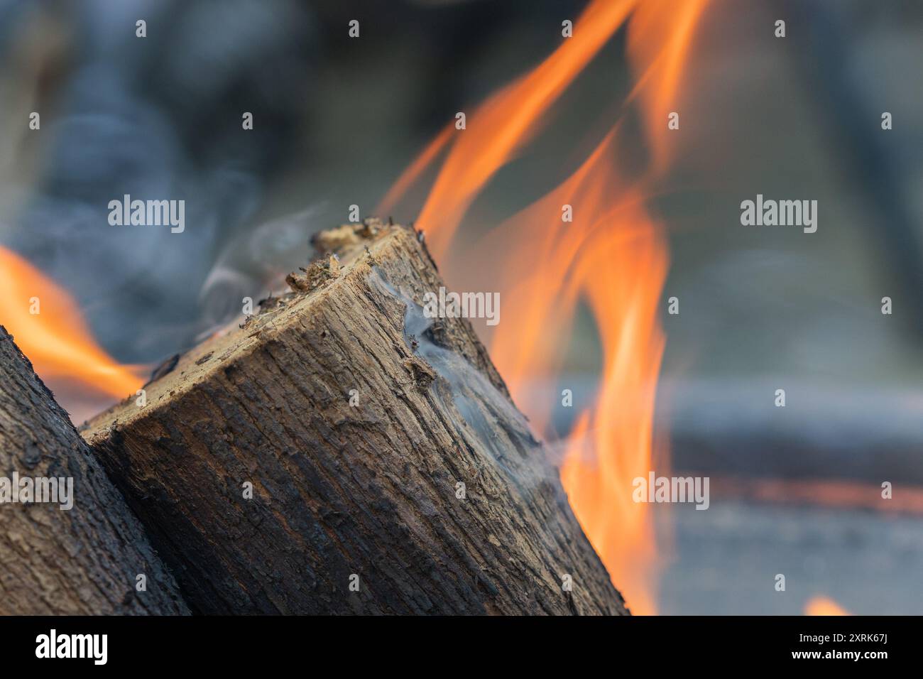Logs burning on a fire pit, summer 2024 Stock Photo - Alamy