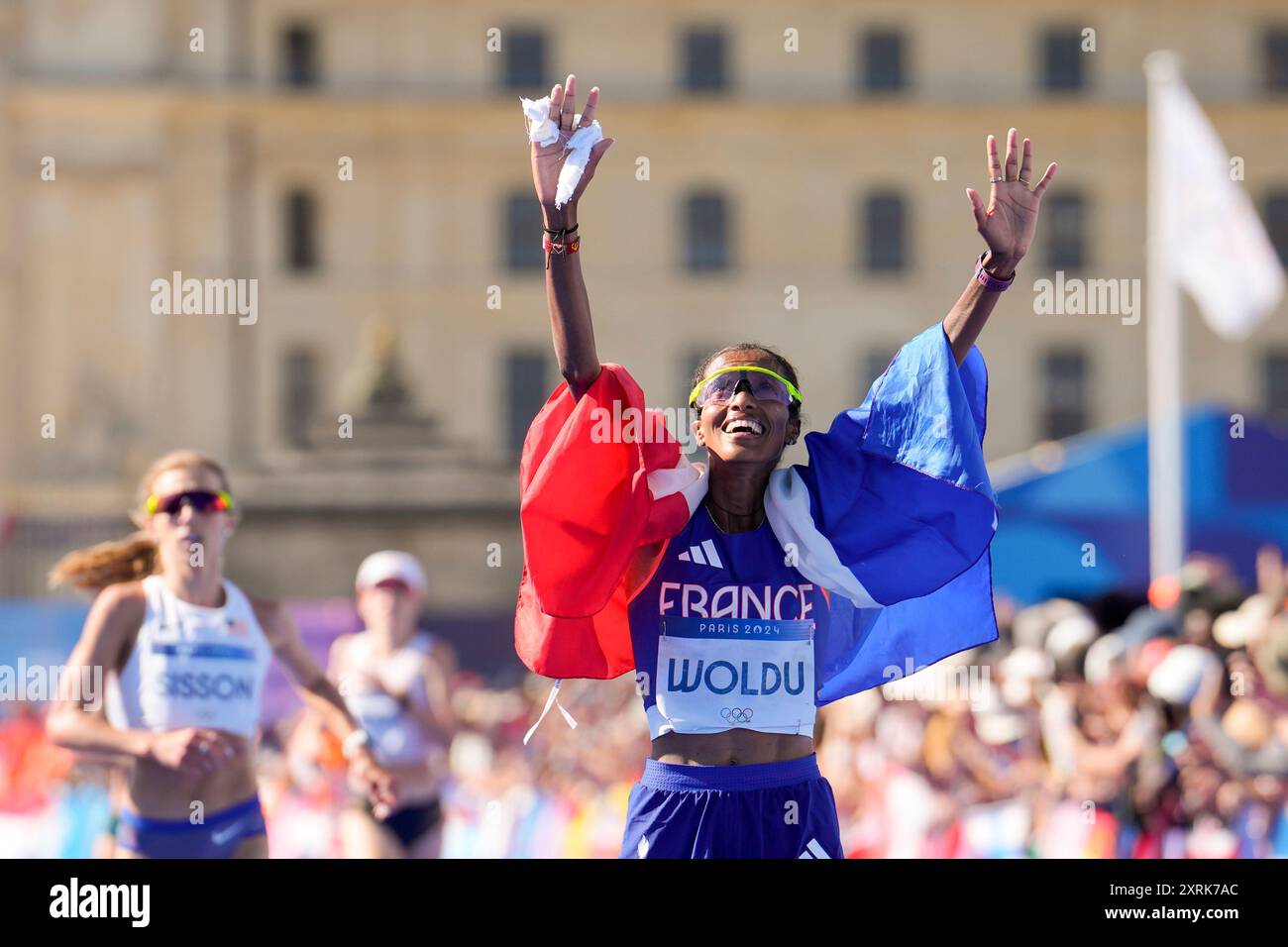 France's Mekdes Woldu, right, celebrates after crossing the finish line ...