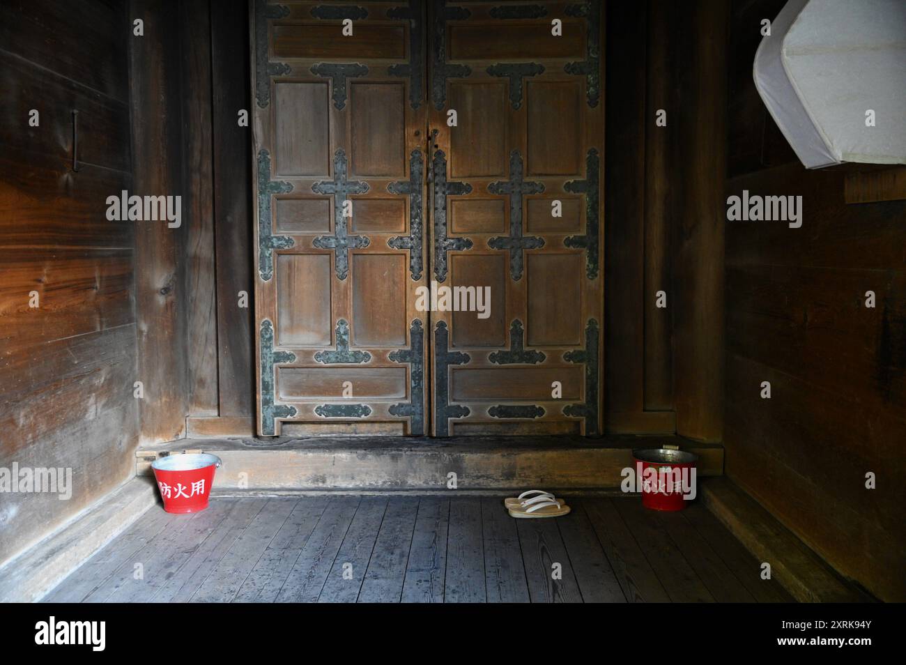 Traditional Japanese house entrance with an antique wooden door, geta ...