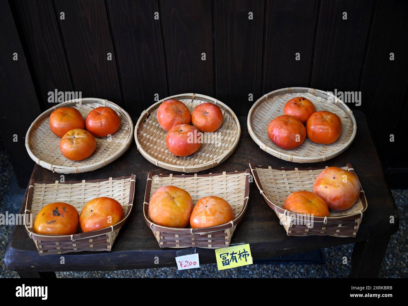 Fresh organic Japanese Kaki persimmon at a local fruit market display ...