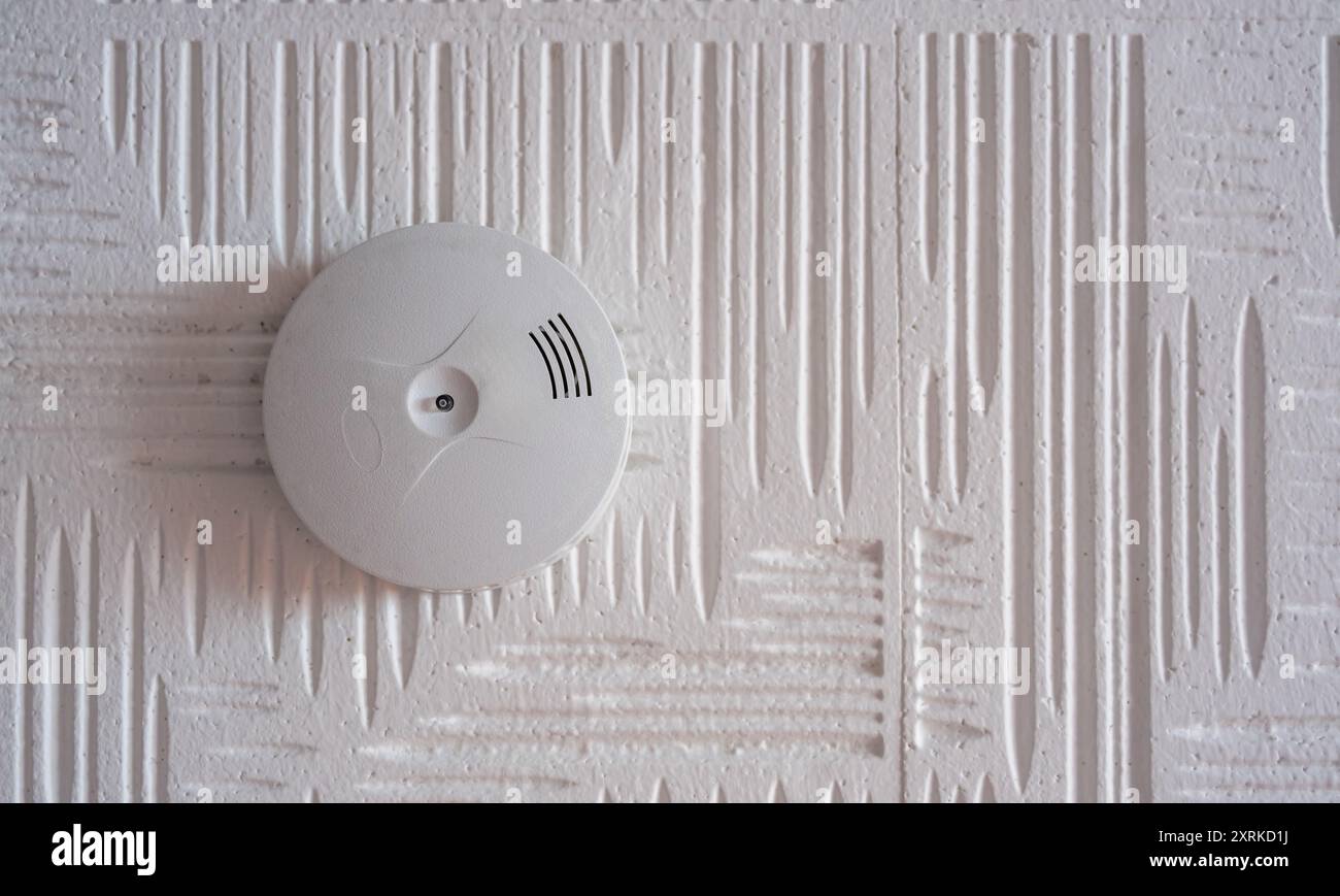 White ceiling mounted fire safety device smoke detector Stock Photo - Alamy