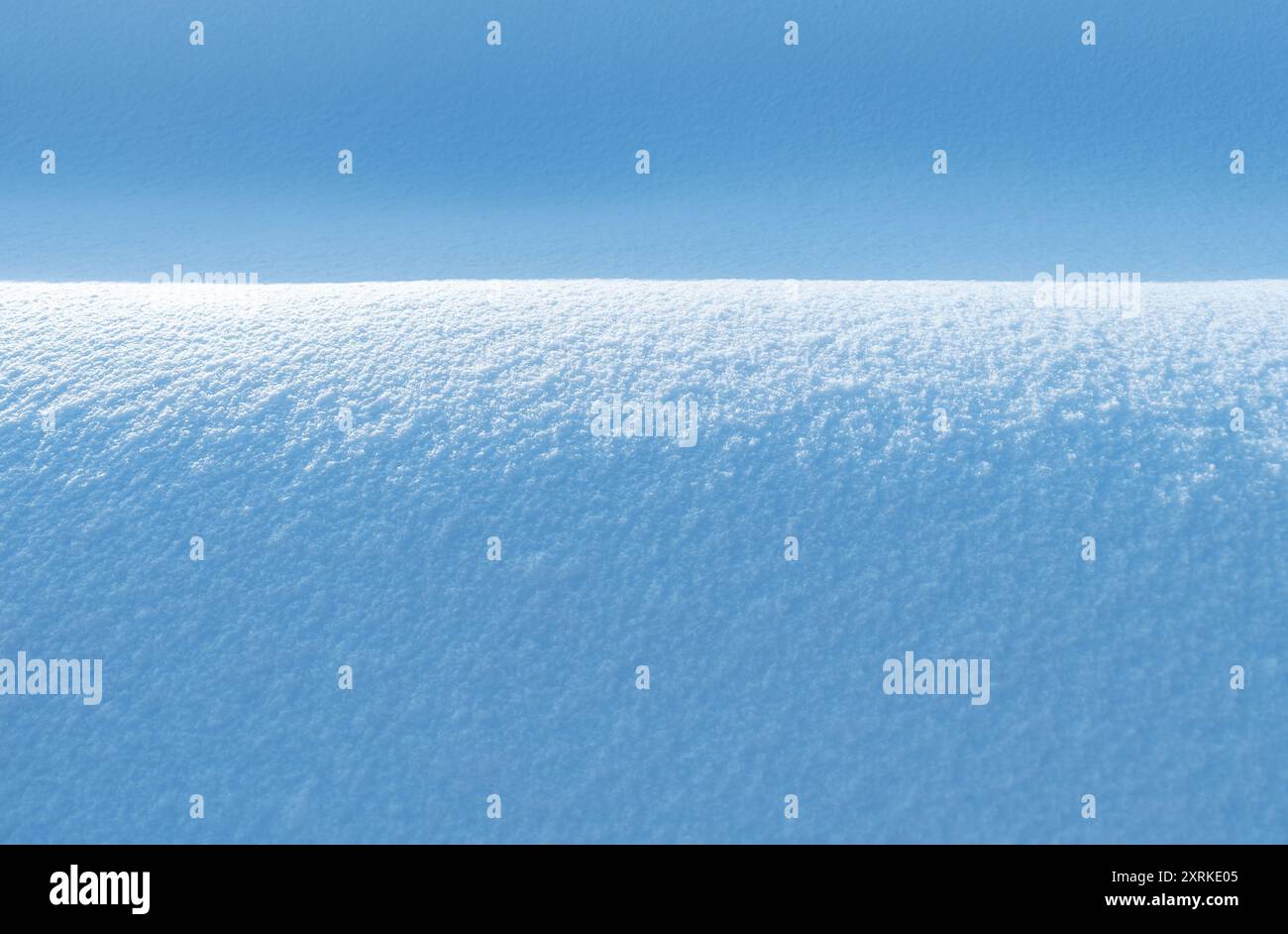 Minimalistic background of a smooth snow bank illuminated by the sun ...