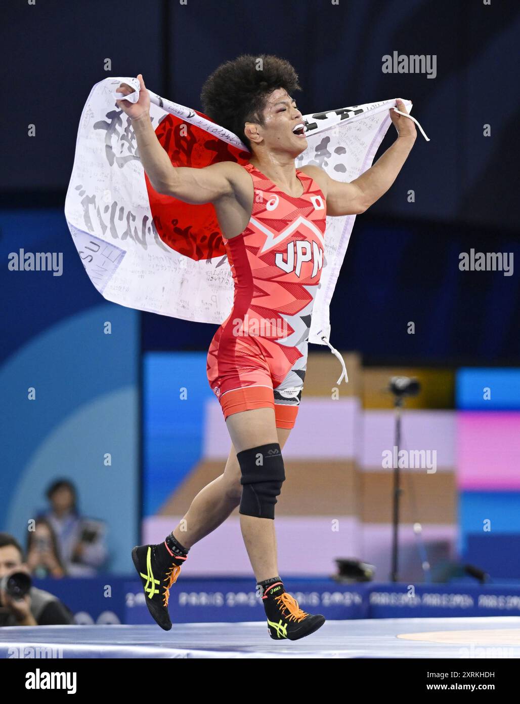 Japan's Kotaro Kiyooka celebrates with his national flag after winning ...
