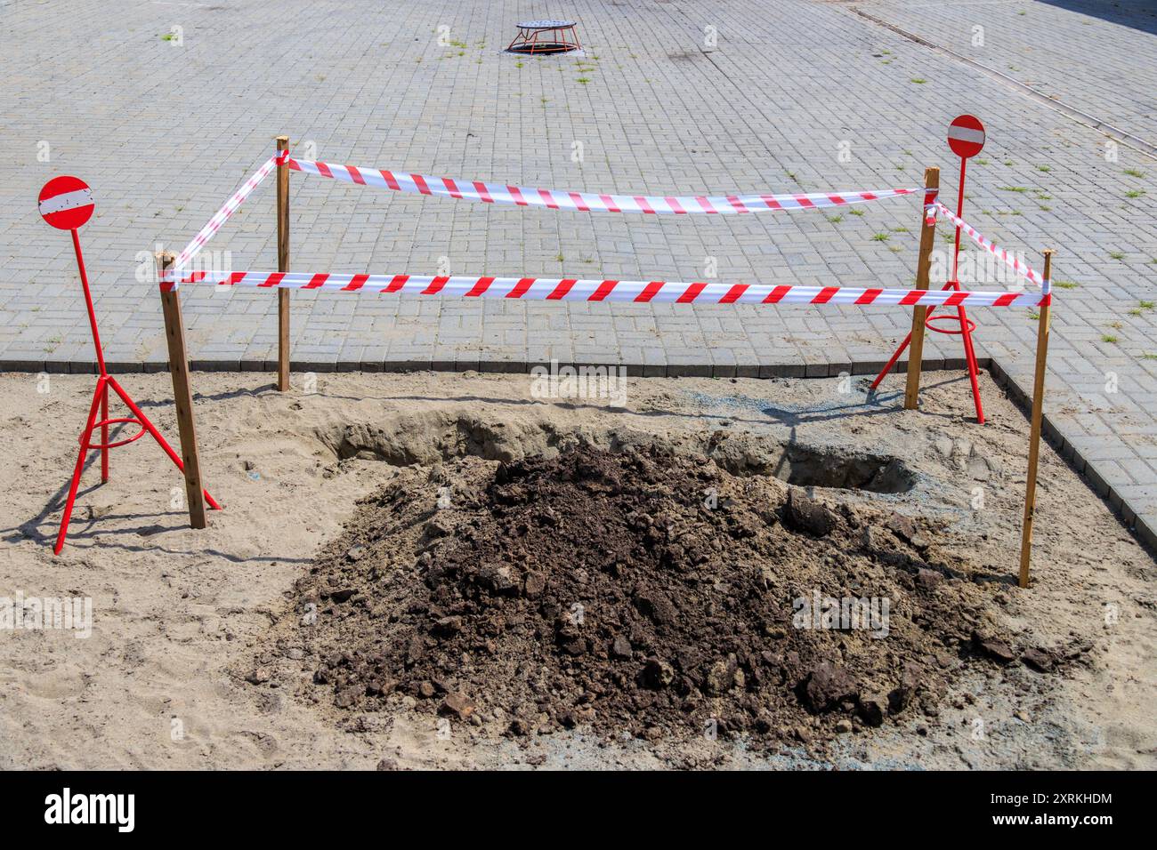The construction site is decorated with wooden barriers with red and ...