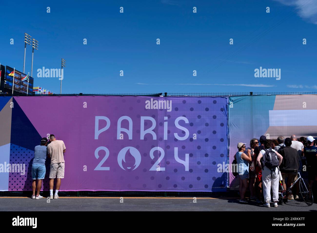 Spectators try to catch a glimpse of activity at the finish line ...