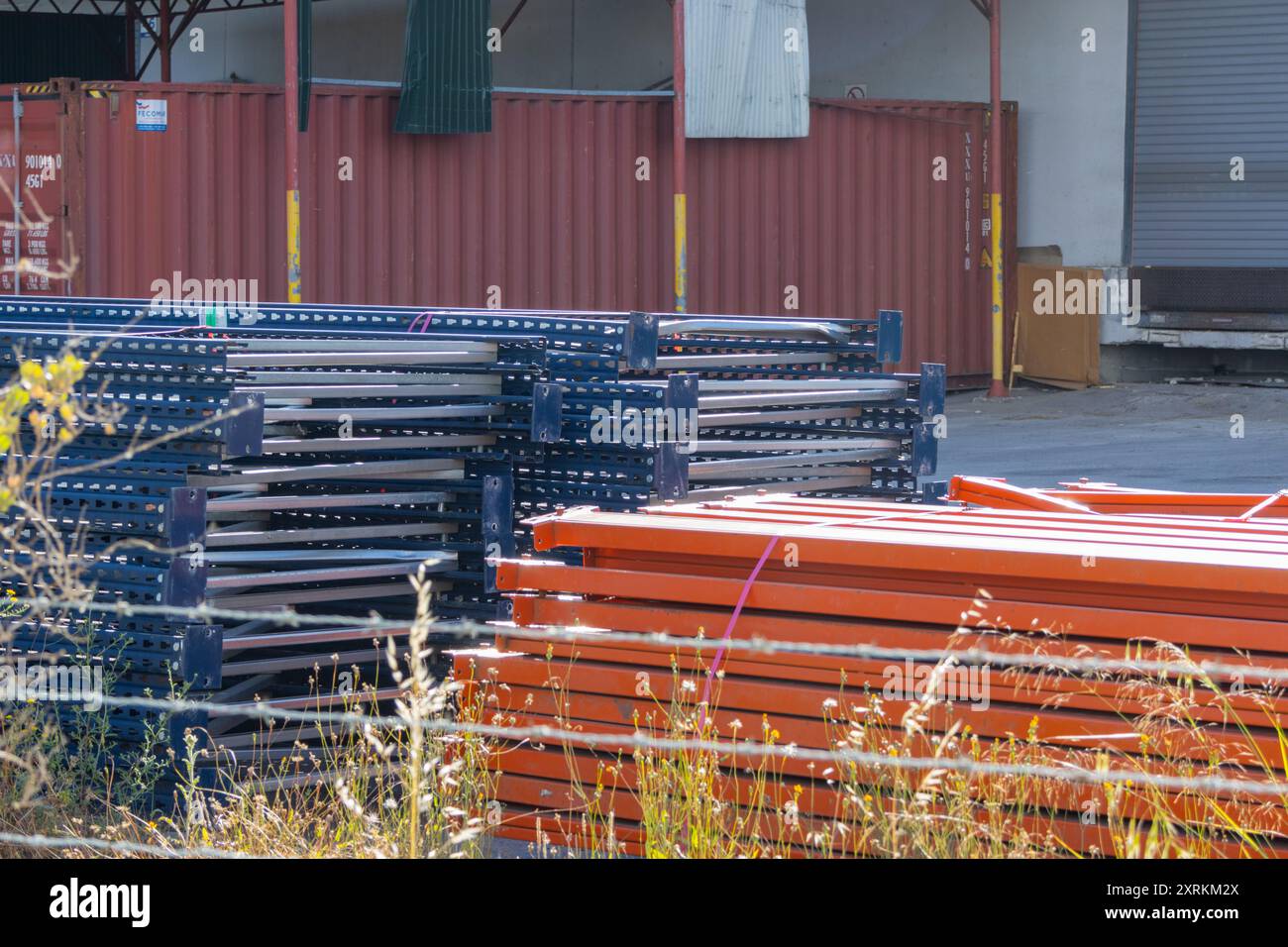 Steel grating for industrial shelving sitting outside a warehouse next ...