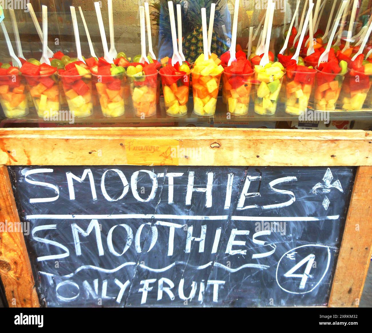 Freshly cut fruits on display of the small shop Stock Photo - Alamy