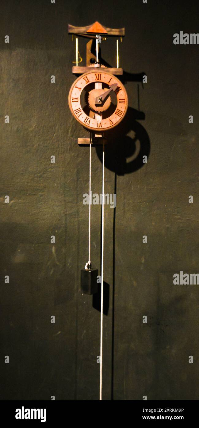 Old, wooden wall clock on display at one of the museums Stock Photo - Alamy