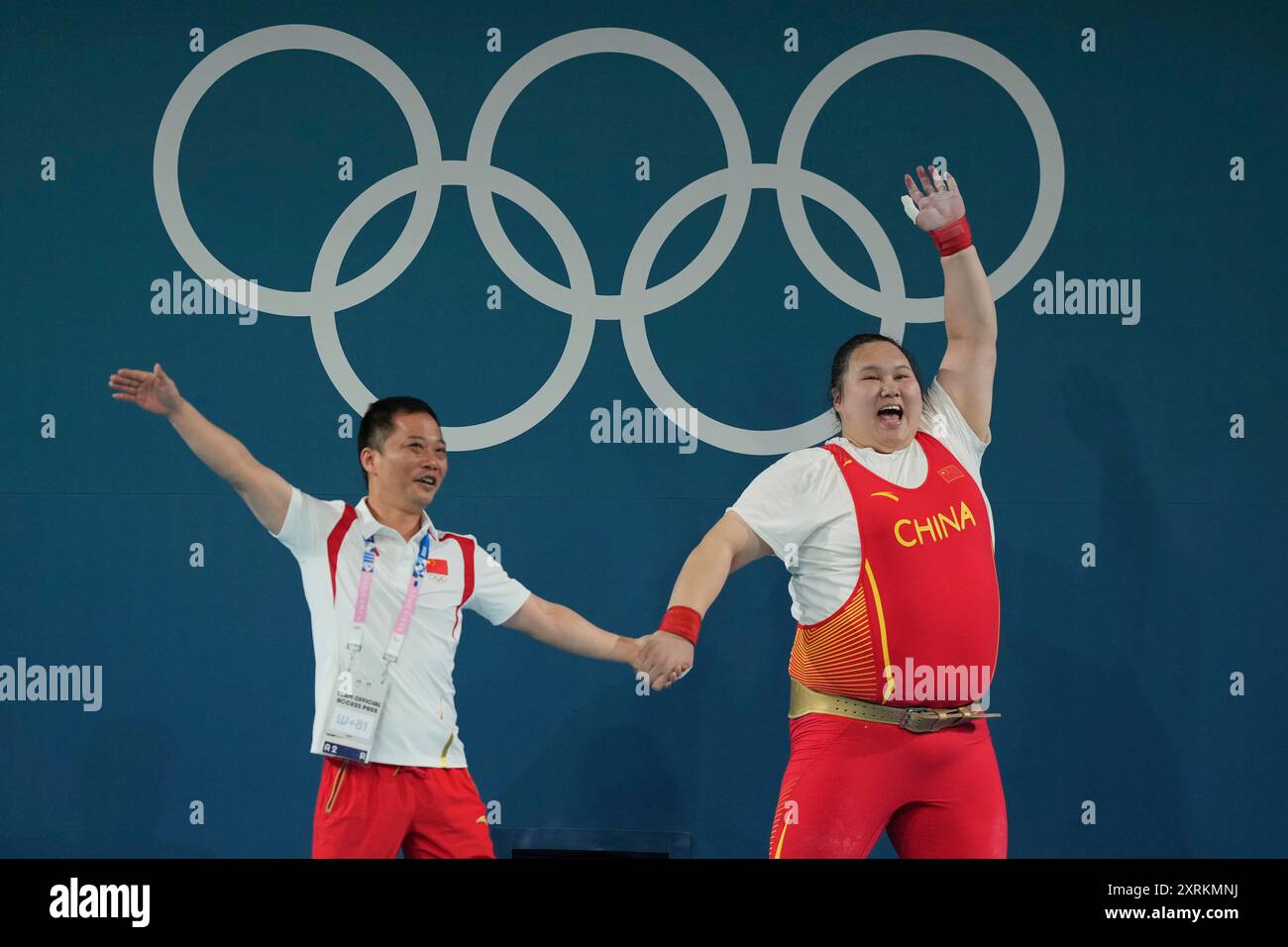 Li Wenwen of China celebrates with her coach after finishing in the ...