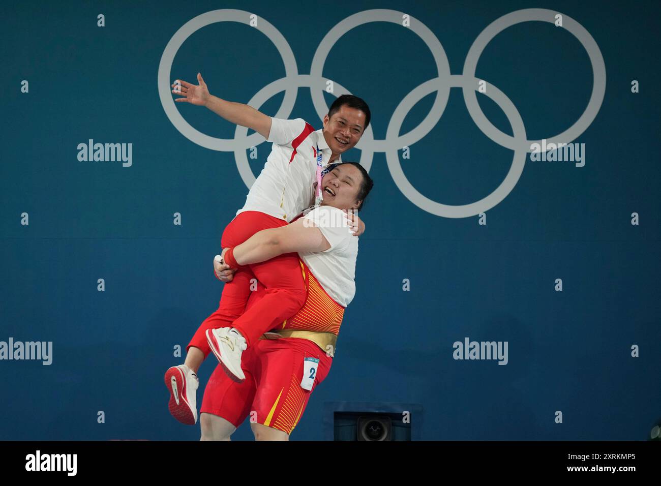 Li Wenwen of China celebrates with her coach finishing in the first ...