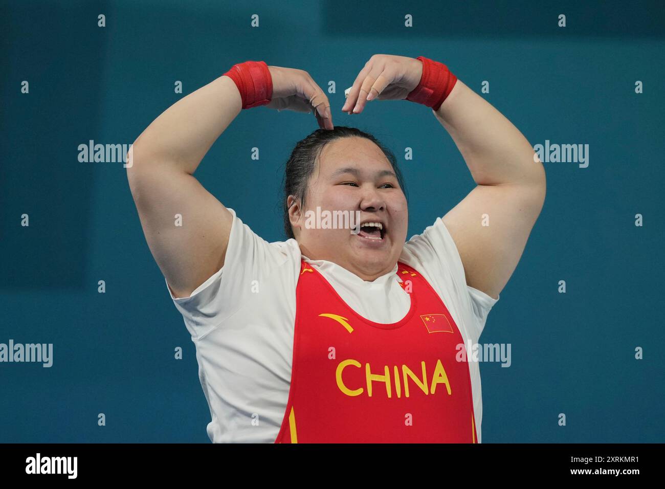 Li Wenwen of China celebrates after finishing in the first place to win ...