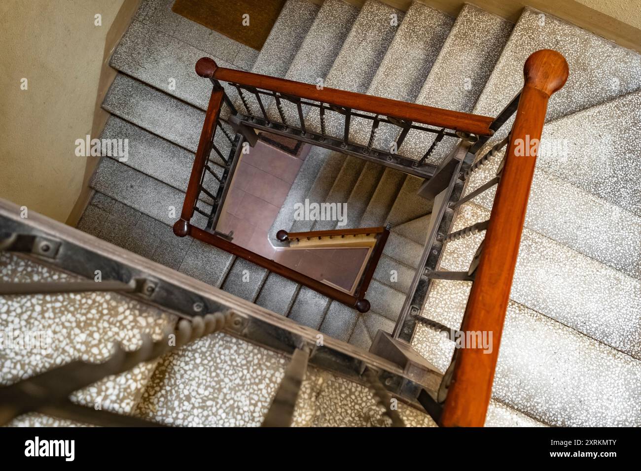 A top view of a staircase with wooden handrails and steps in a modern ...