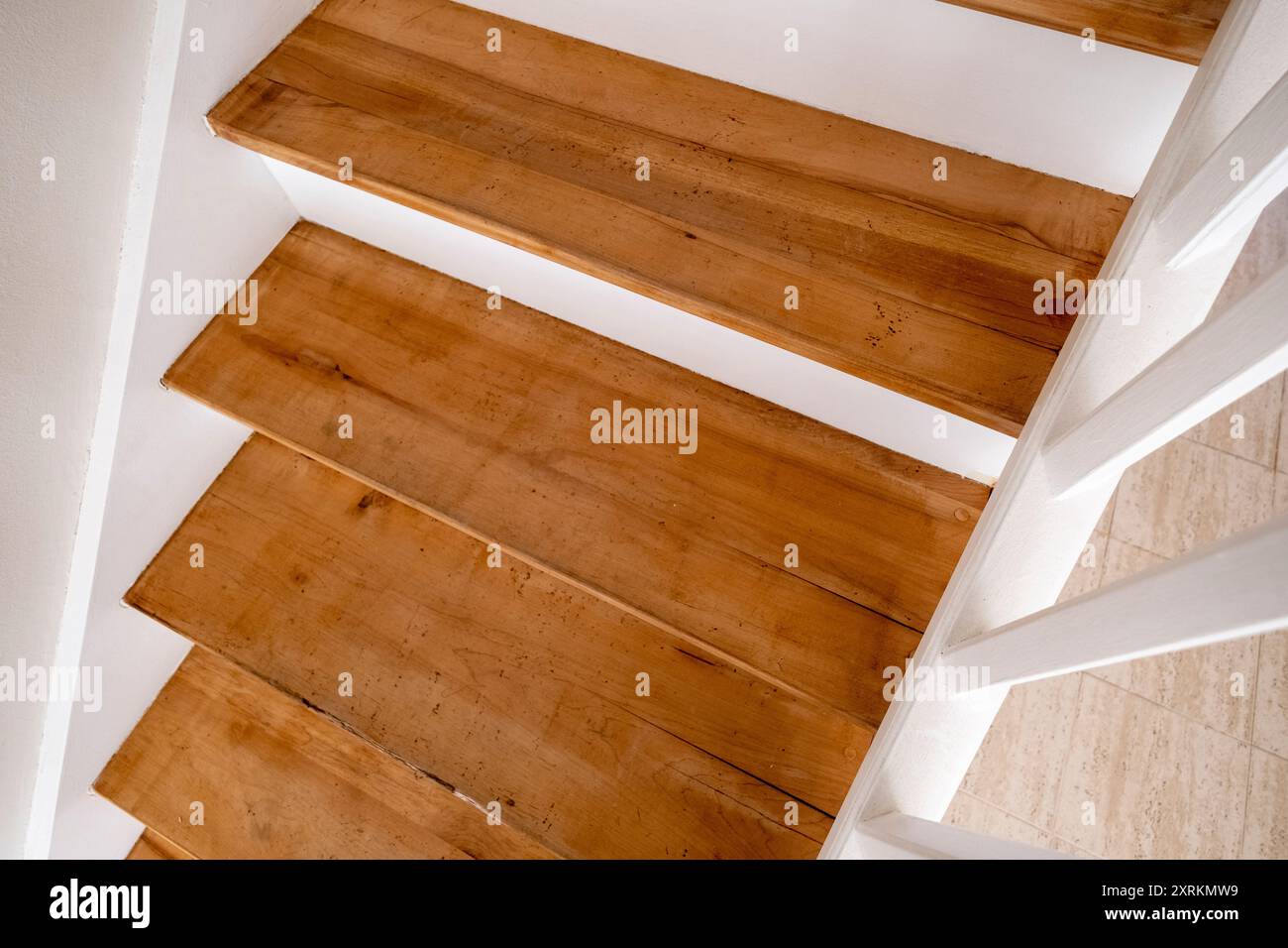 A top view of a staircase with wooden handrails and steps in a modern ...