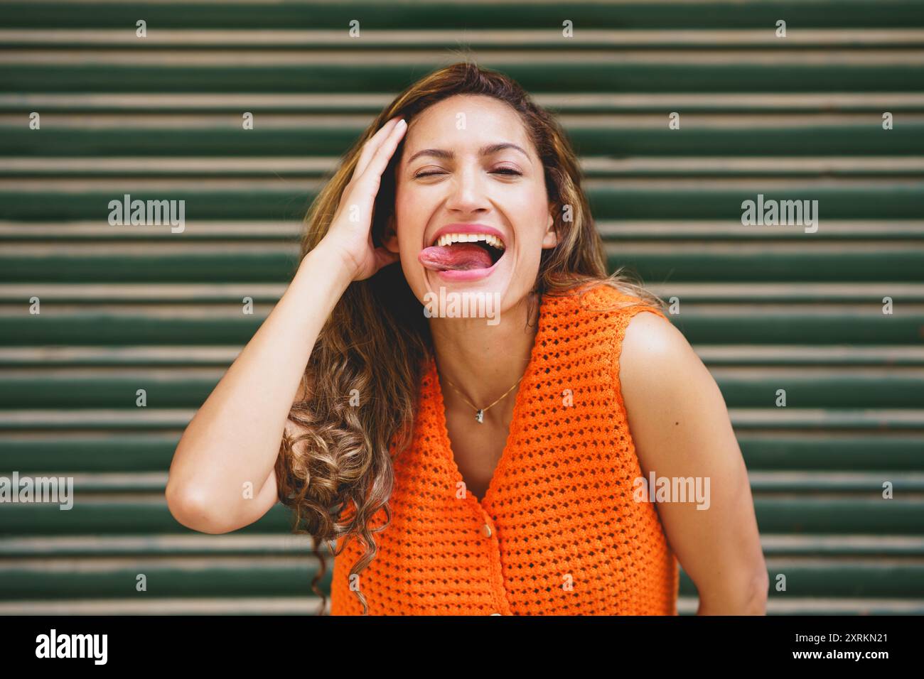 Woman flirting sticking the tongue out smiling at camera Stock Photo ...