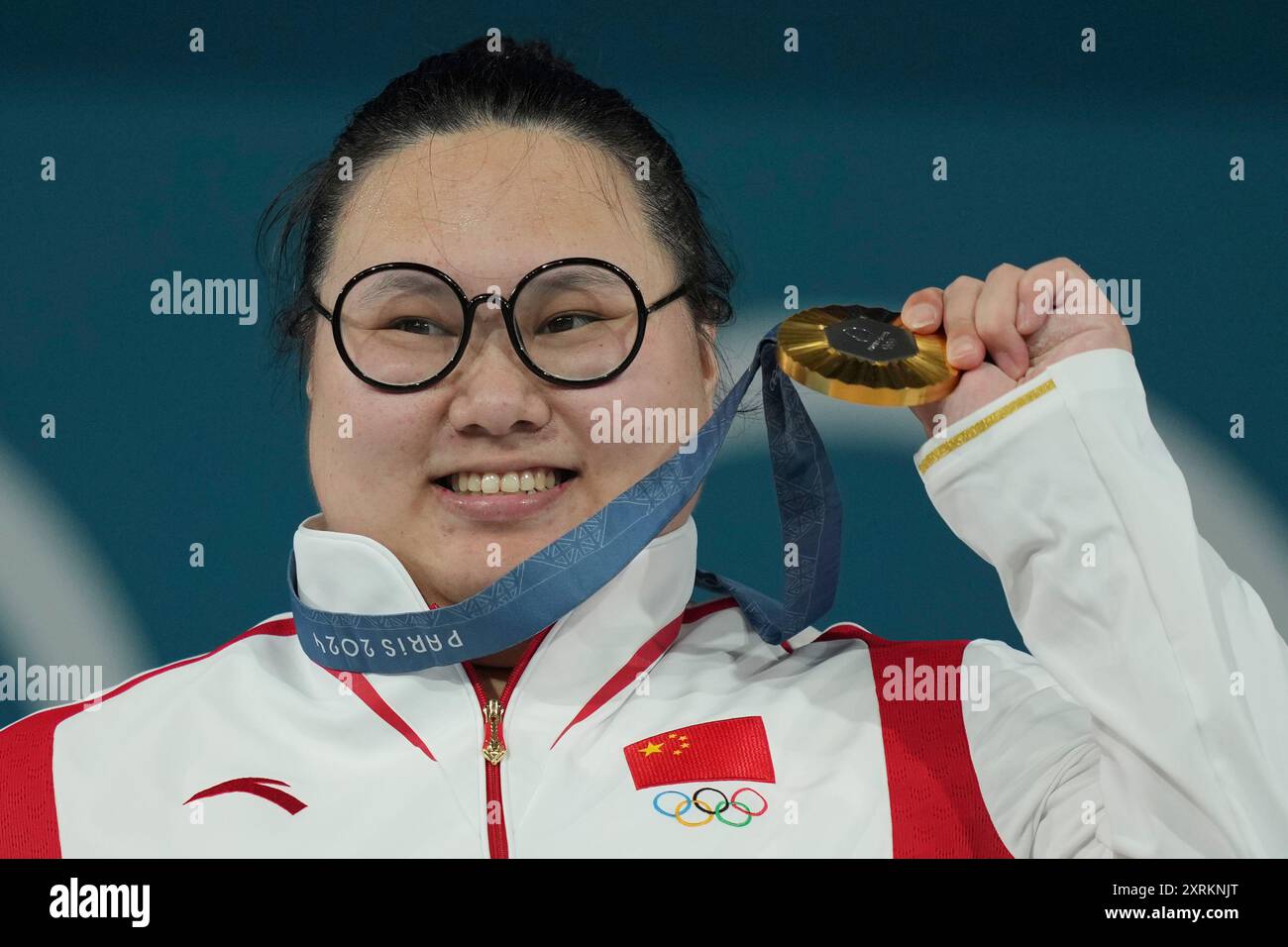 Gold medalist Li Wenwen of China celebrates on the podium during the ...
