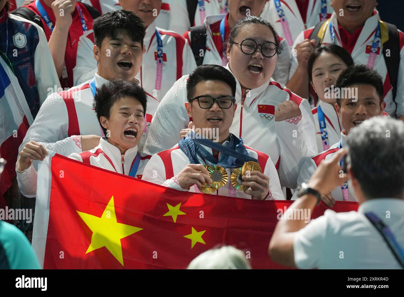 China's weightlifting gold medalists, top from left, Liu Huanhua, Li ...