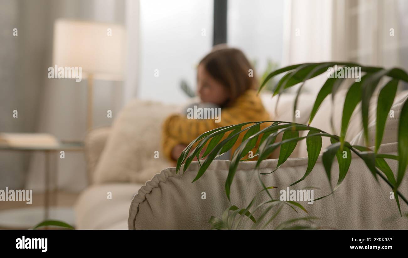 Bored disappointed little Caucasian girl schoolgirl daughter kid hug ...