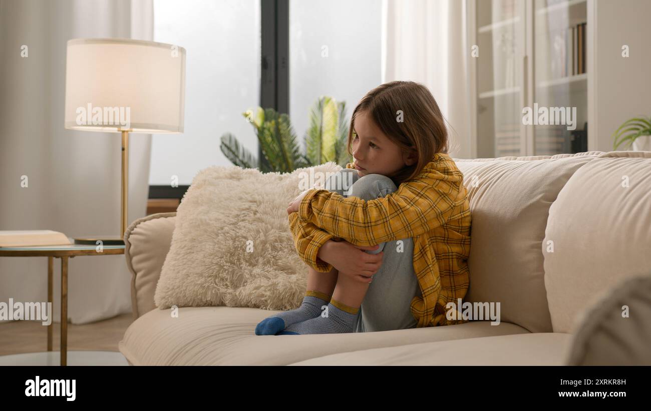 Bored disappointed little Caucasian girl schoolgirl daughter kid hug ...