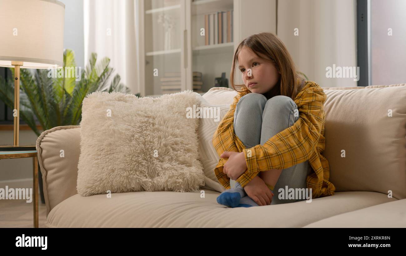 Bored disappointed little Caucasian girl schoolgirl daughter kid hug ...